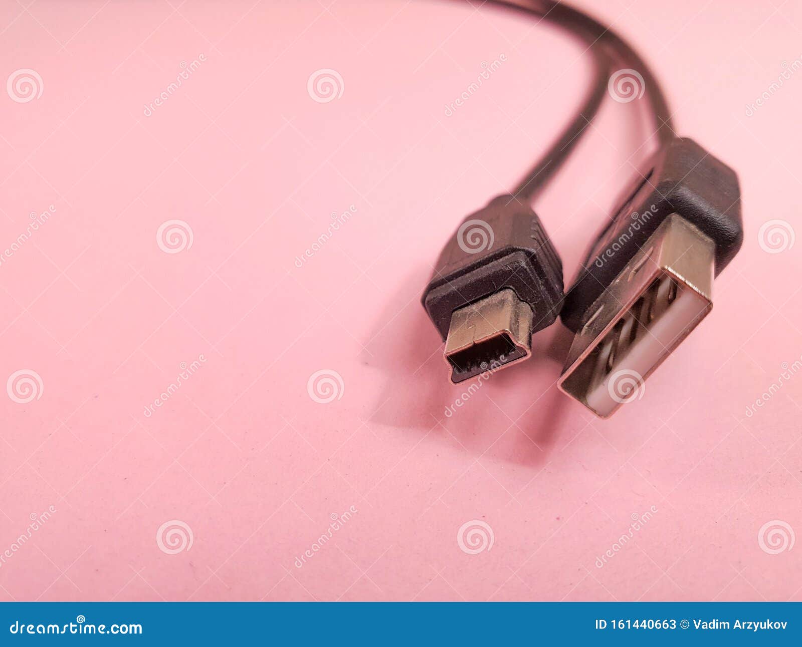 Wire with USB Connector and Mini USB on a Pink Background Close-up ...