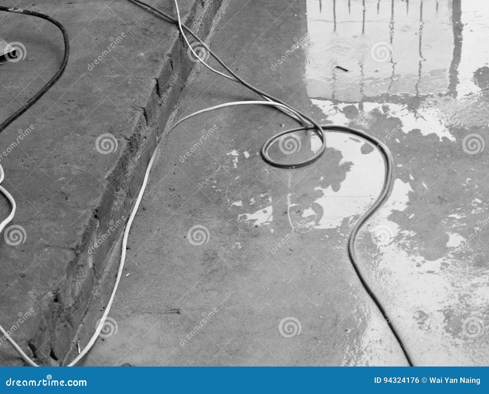 WIRE on WET CONCRETE GROUND Stock Photo - Image of rainy, background ...