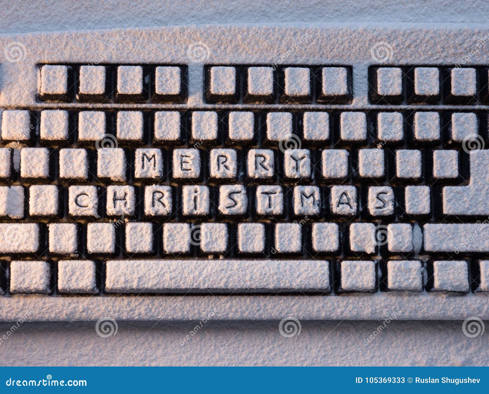 Computer Keyboard Covered with White Snow and Lit by Warm Light with ...