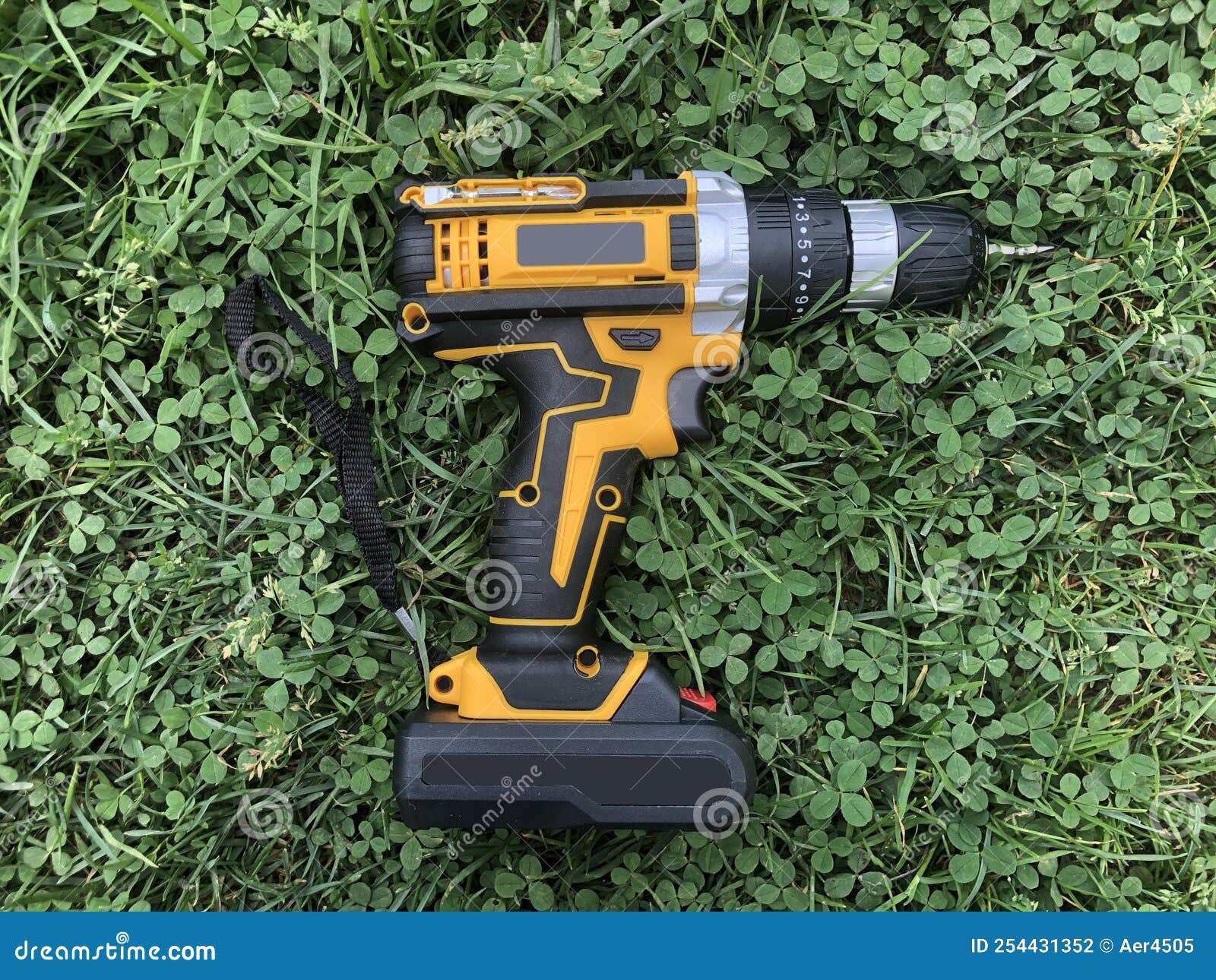 Rechargeable Yellow and Black Screwdriver Stock Photo - Image of grass ...