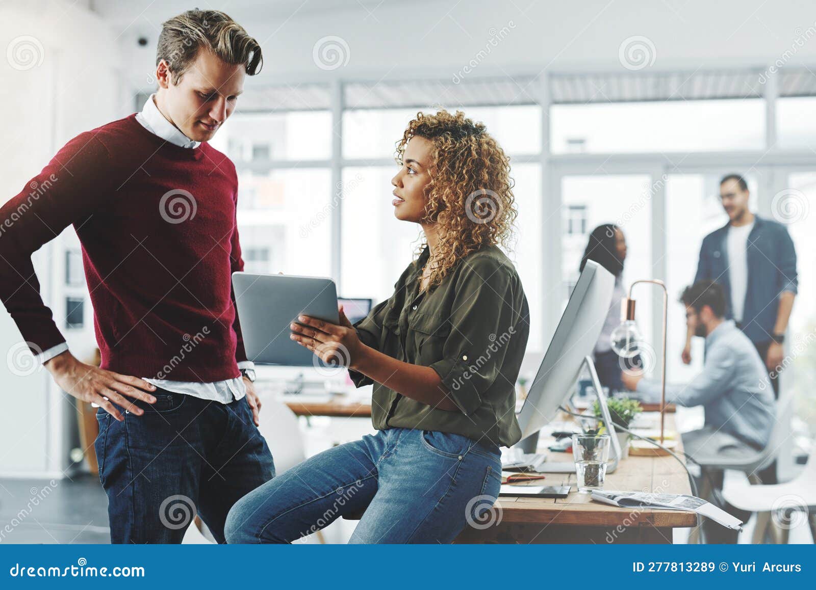 Wireless Tech Keeps Their Office Productive. Two Young Colleagues Using ...