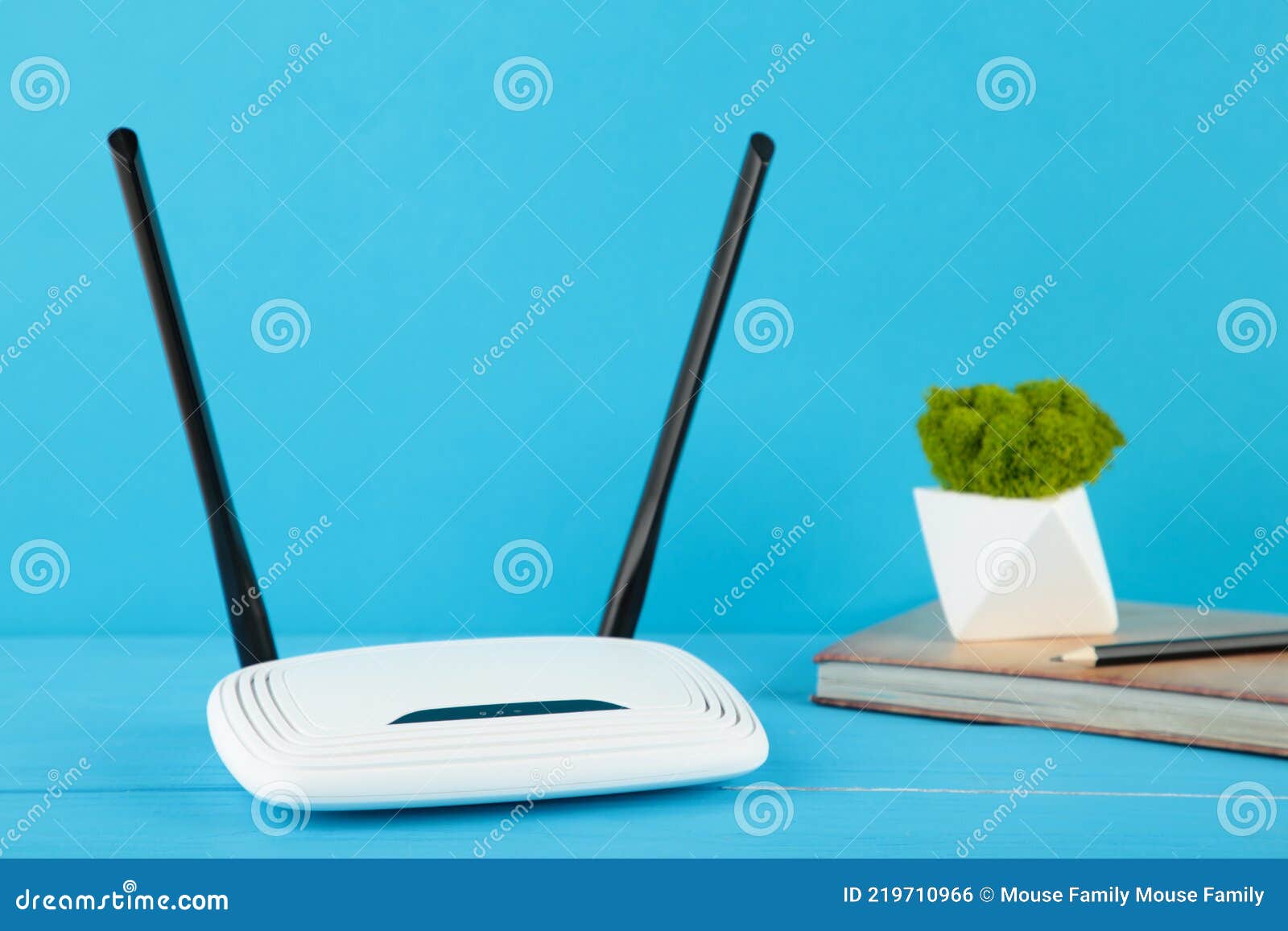 Wireless Wi-Fi Router on Blue Background with Notebook on Beige Stock ...