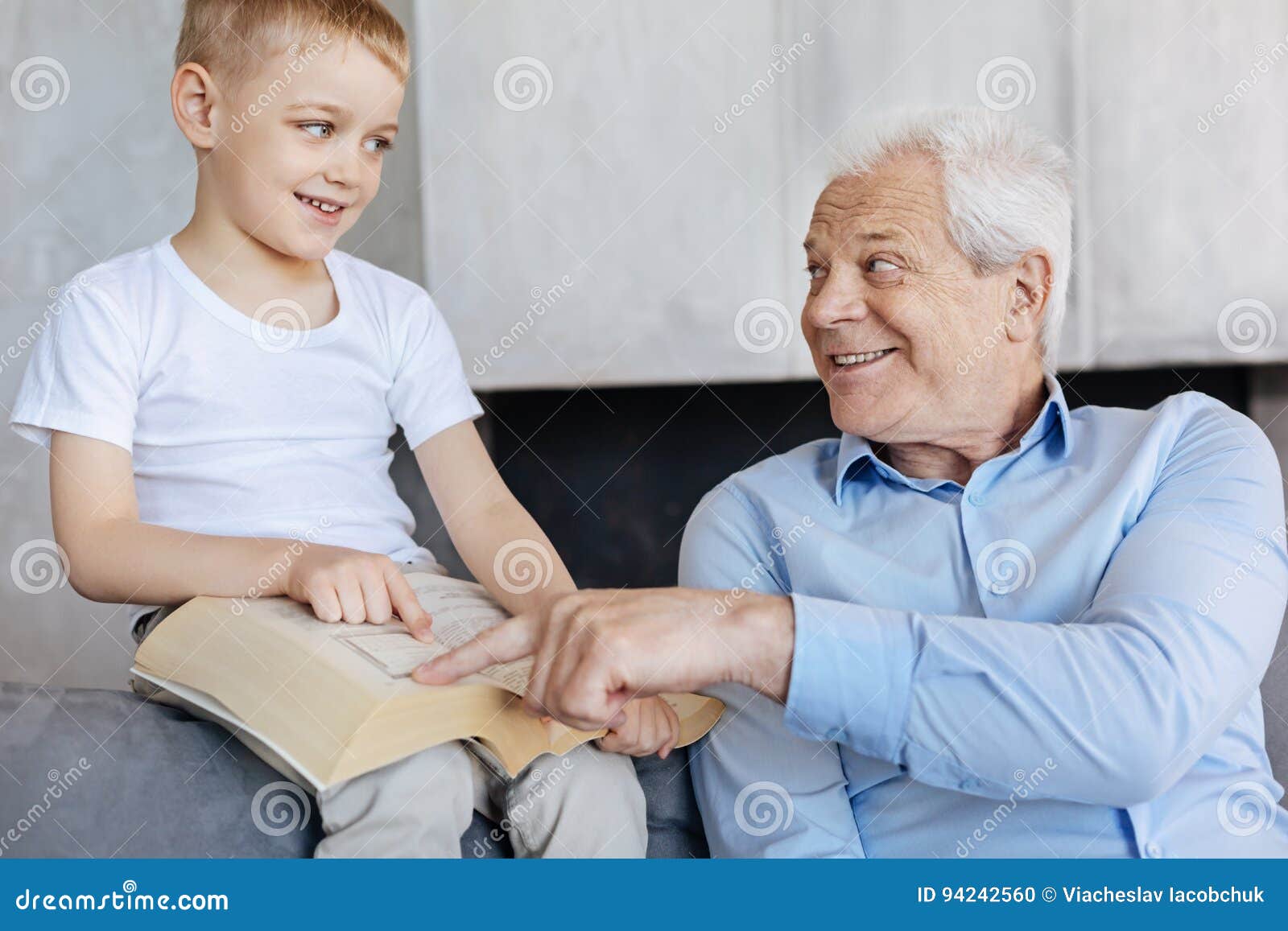 Wise Elderly Man Explaining Something To His Grandson Stock Photo ...