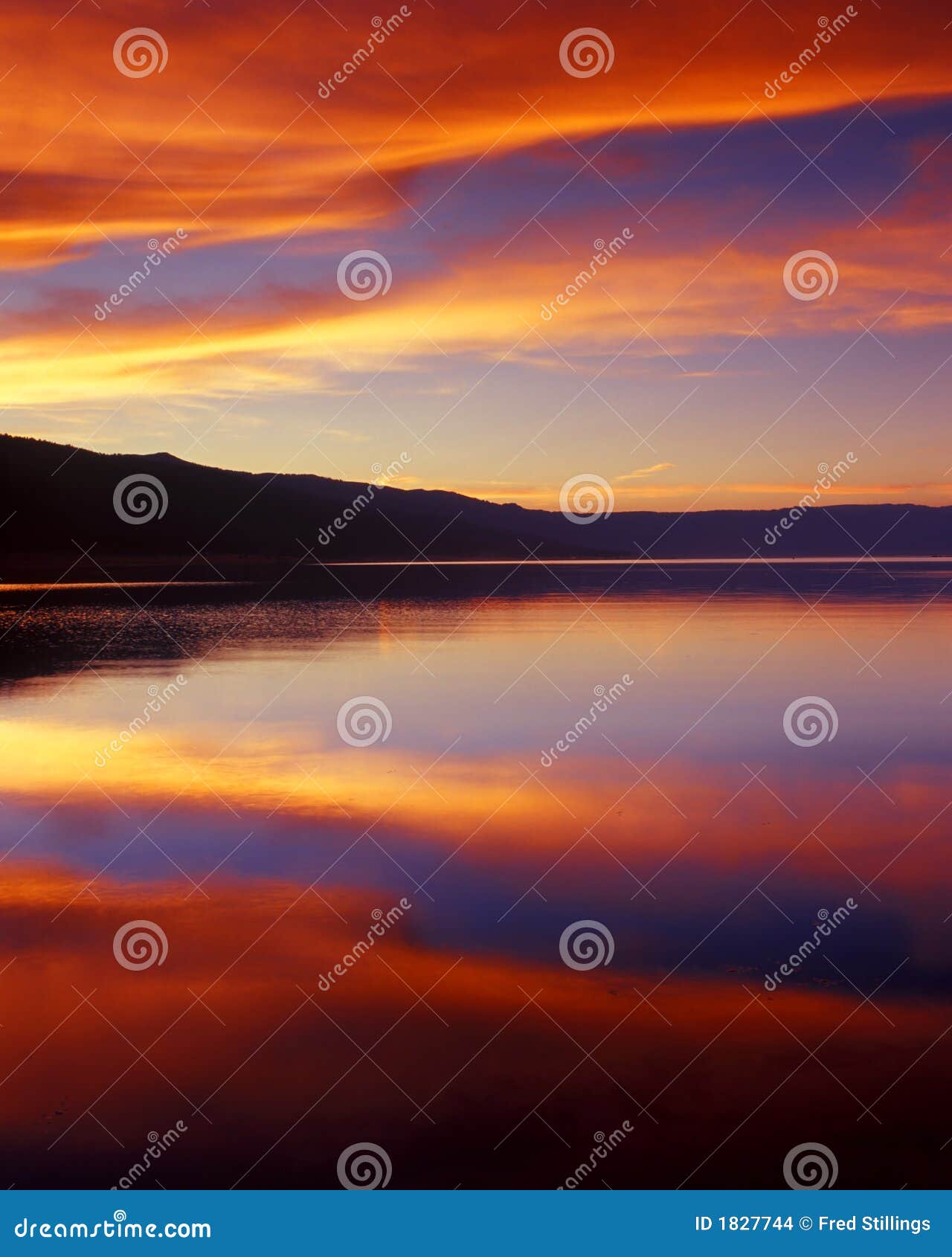 Wispy Clouds Over Lake at Sunset Stock Photo - Image of darkens ...