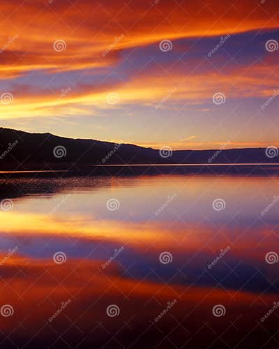 Wispy Clouds Over Lake at Sunset Stock Photo - Image of darkens ...