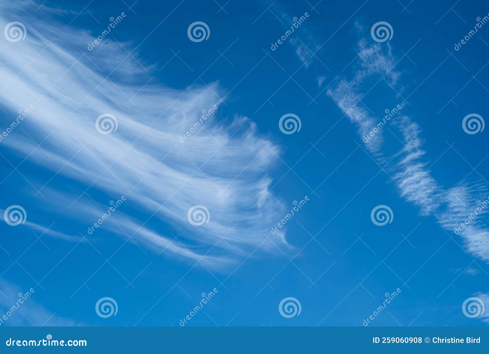 Wispy White Clouds Against a Bright Blue Sky Stock Photo - Image of ...