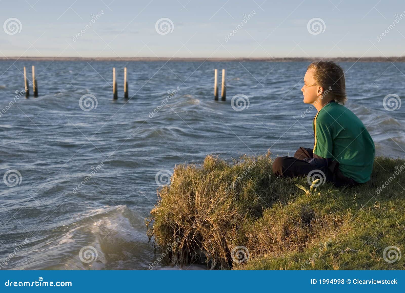 Wistful Boy on lake stock photo. Image of hoping, sitting - 1994998