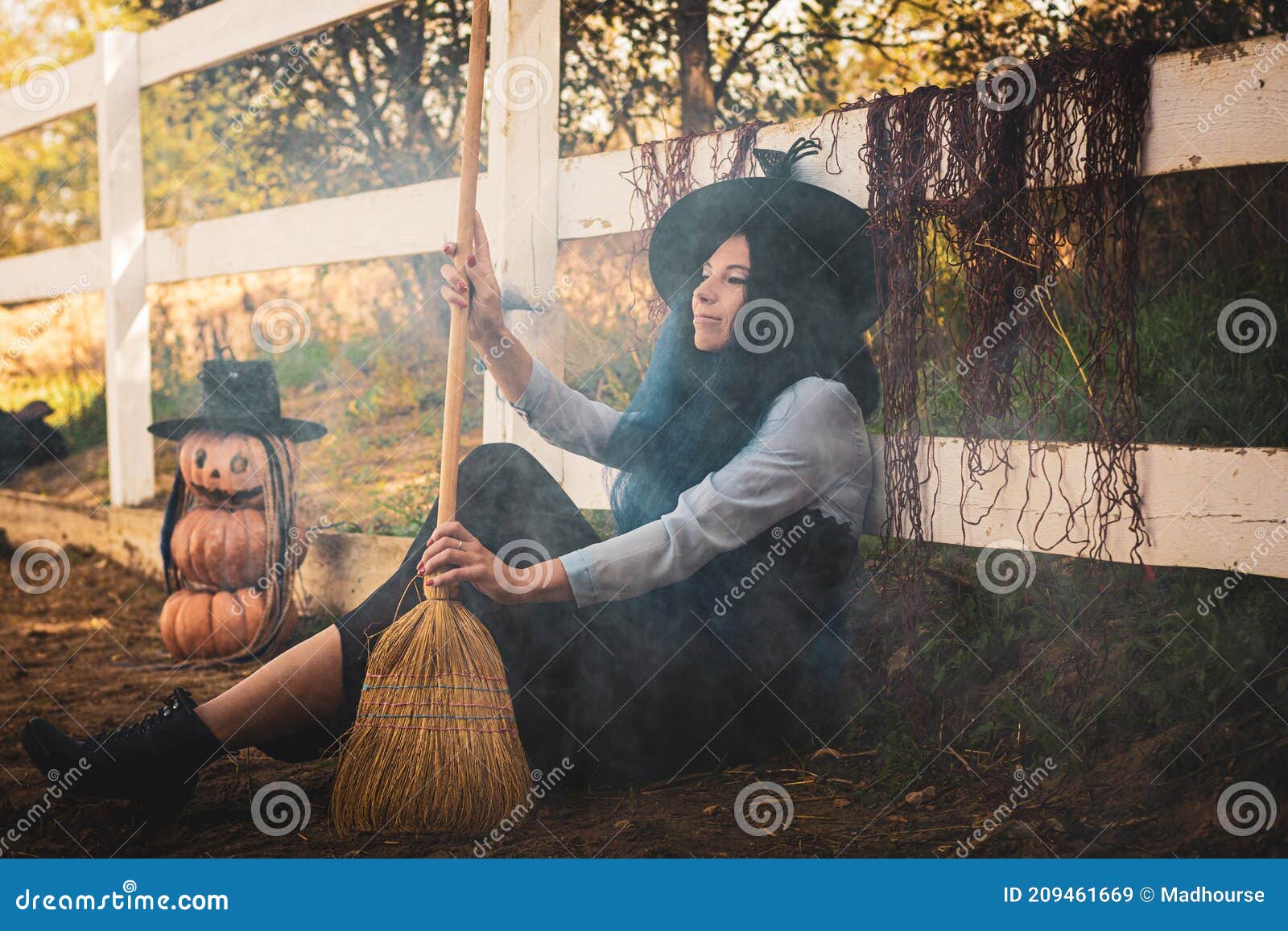 The Witch Sits by the Fence on the Farm and Blows the Smoke with a ...