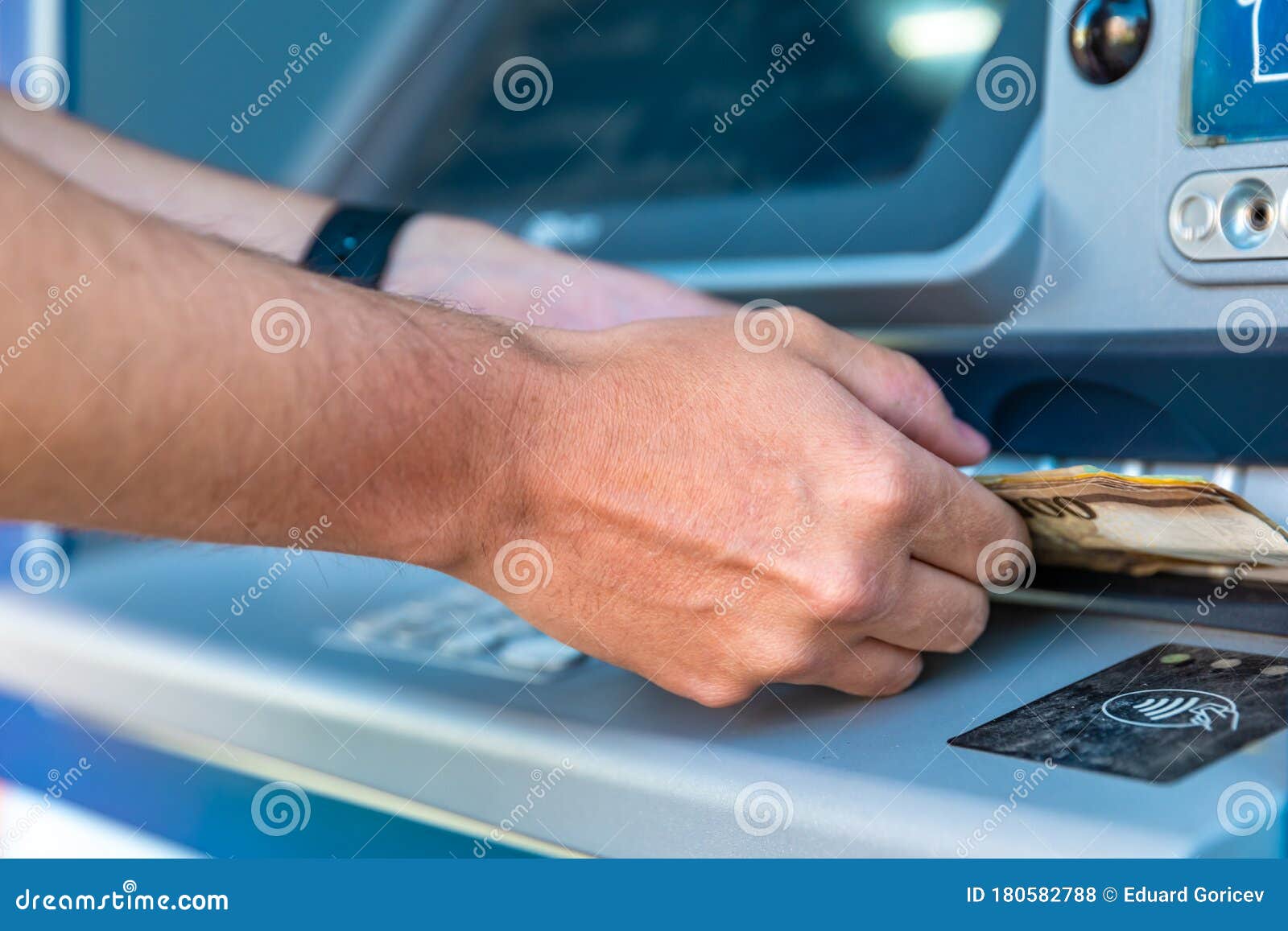 Withdraw cash from an ATM stock photo. Image of machine - 180582788