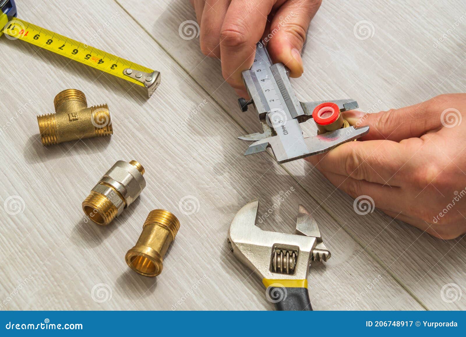 The Wizard Measures the Size of Fitting Using a Caliper before ...