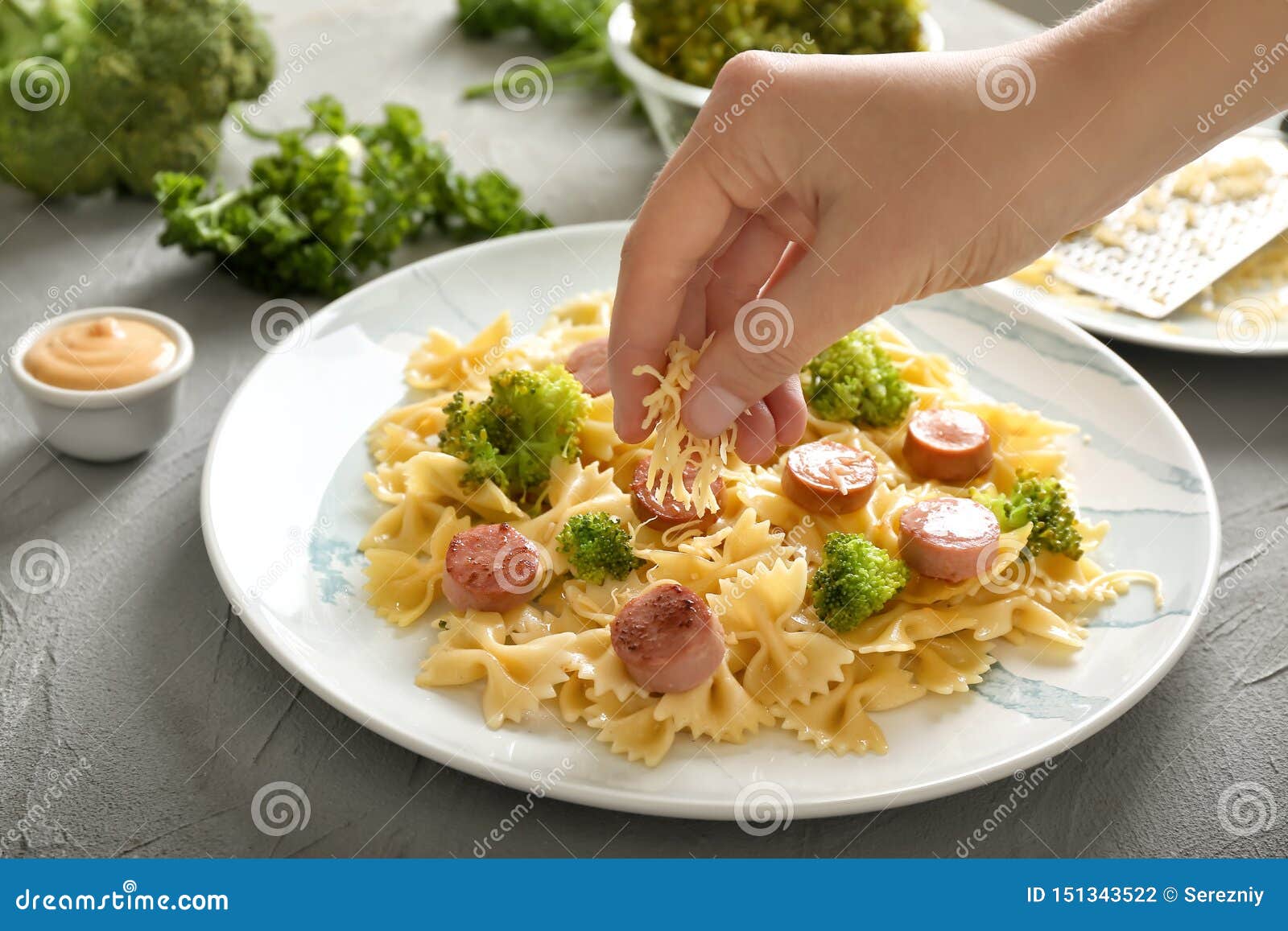 Woman Adding Cheese To Pasta on Plate, Closeup Stock Photo - Image of ...