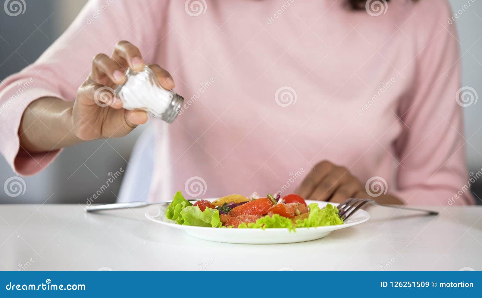 Woman Adding Too Much Salt To Her Food, Unhealthy Eating, Dehydration ... Woman Adding Too Much Salt To Her Food, Unhealthy Eating, Dehydration ...