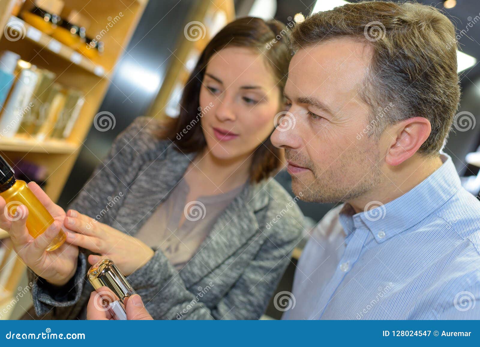 Woman Advising Man in Cosmetics Store Stock Image - Image of guidance ...