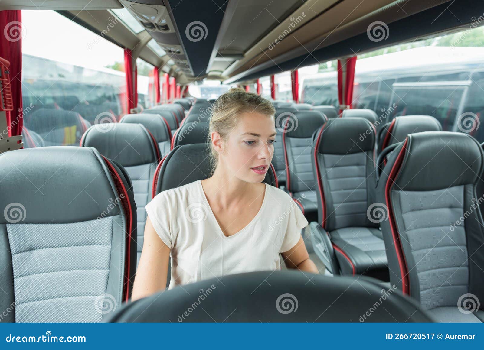 Woman alone in bus stock image. Image of communication - 266720517