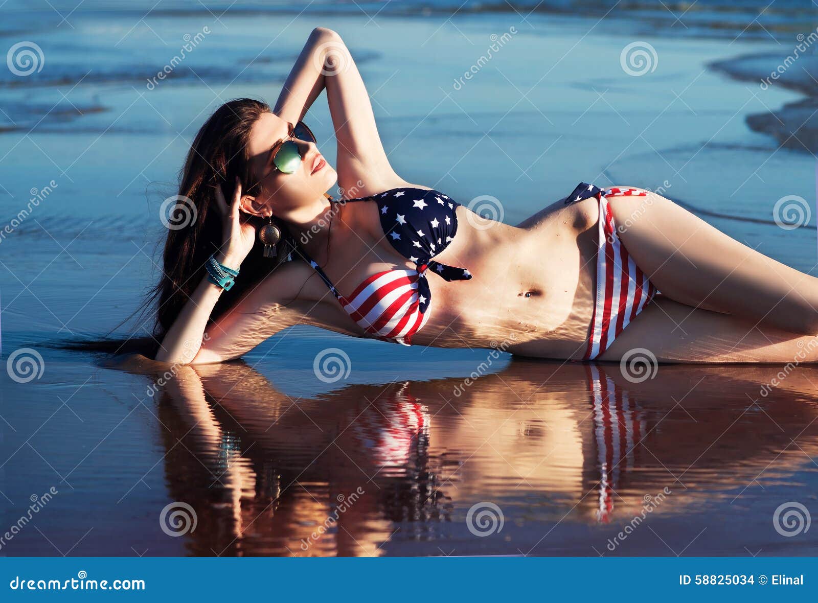 Woman In In American Flag Bikini In Water Sea Waves Fashion