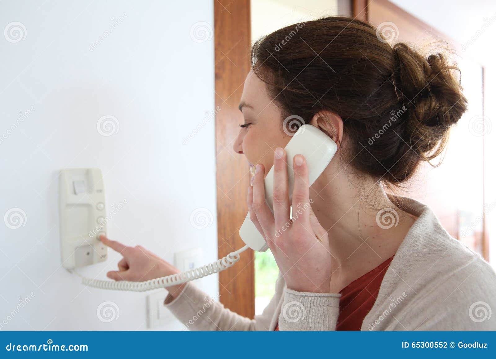 Woman Answering Security Door Phone Stock Photo - Image of woman ...