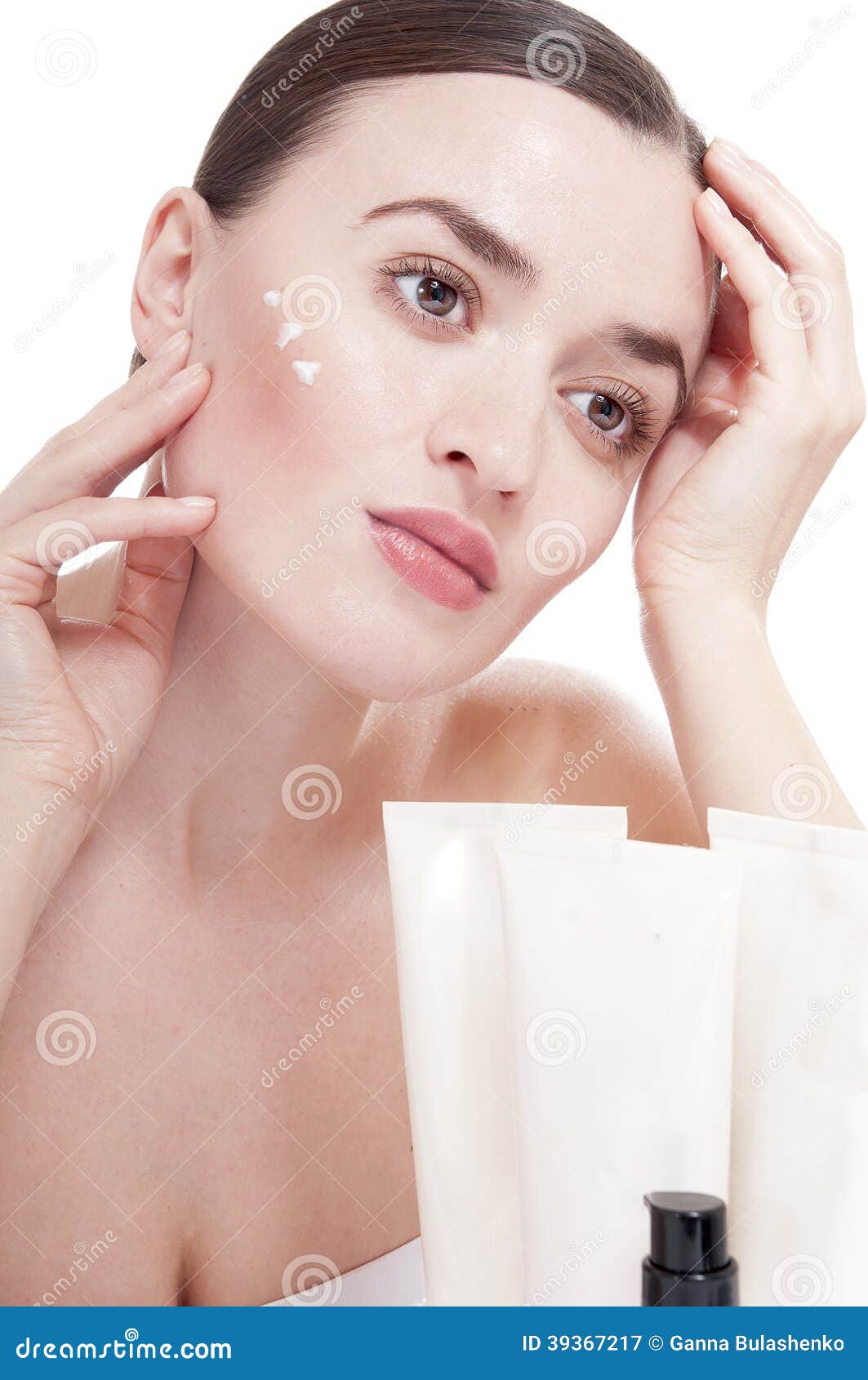 Woman Applying Cosmetic Cream Treatment On Her Face Stock Image