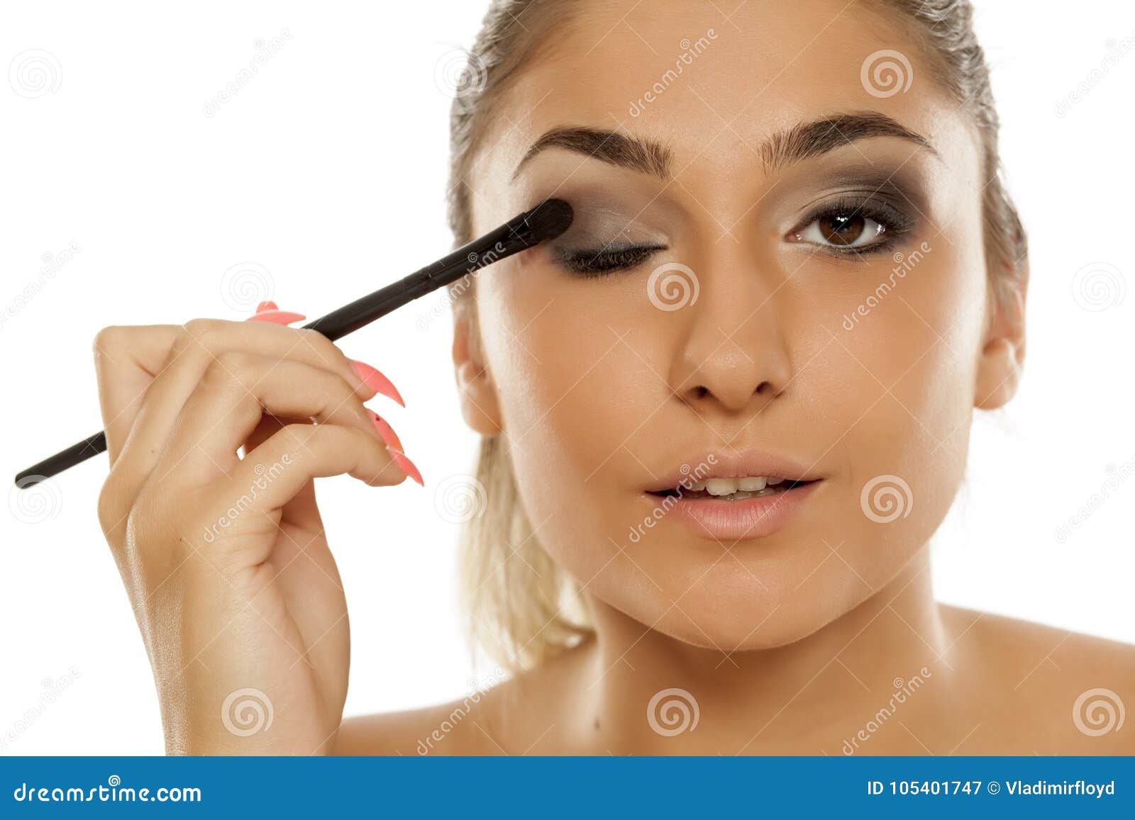 Woman applying eye shadow stock image. Image of powder - 105401747