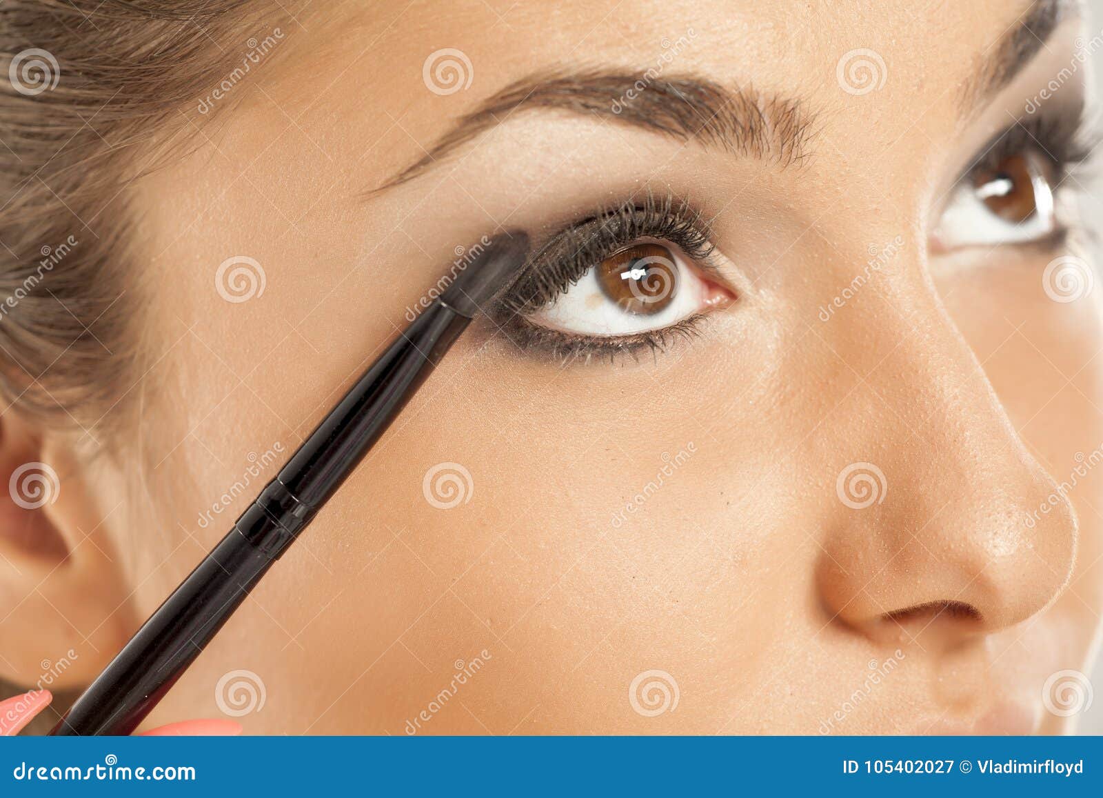 Woman applying eye-shadow stock image. Image of pretty - 105402027