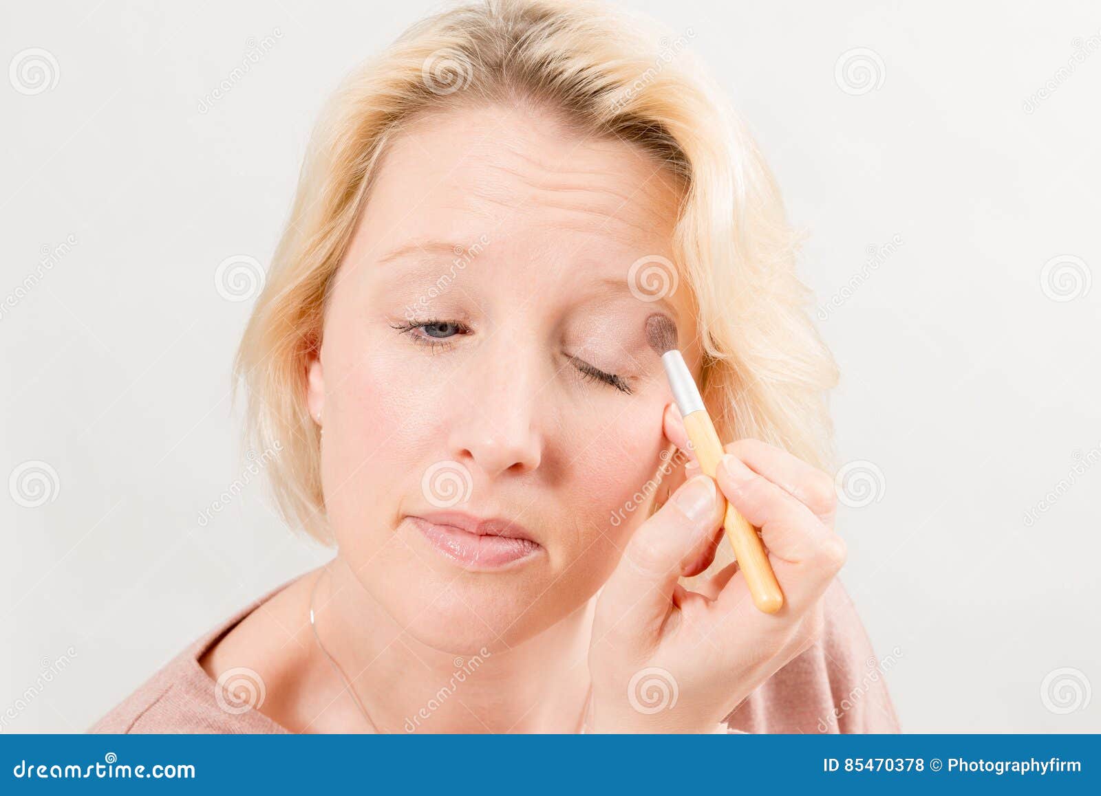 Woman Applying Eyeshadow on Left Eyelid Stock Photo - Image of styling ...