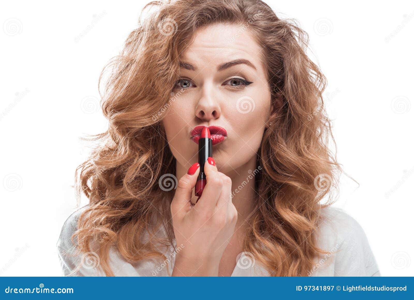 Woman Applying Lipstick and Looking at Camera Stock Image - Image of ...