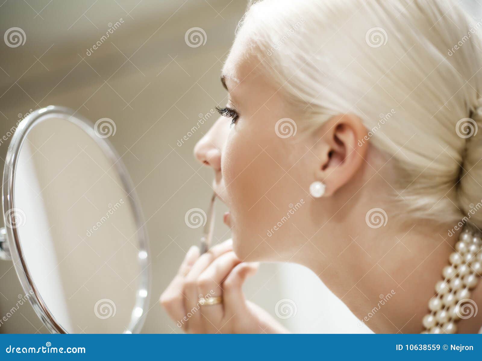 Woman applying make-up stock image. Image of charming - 10638559