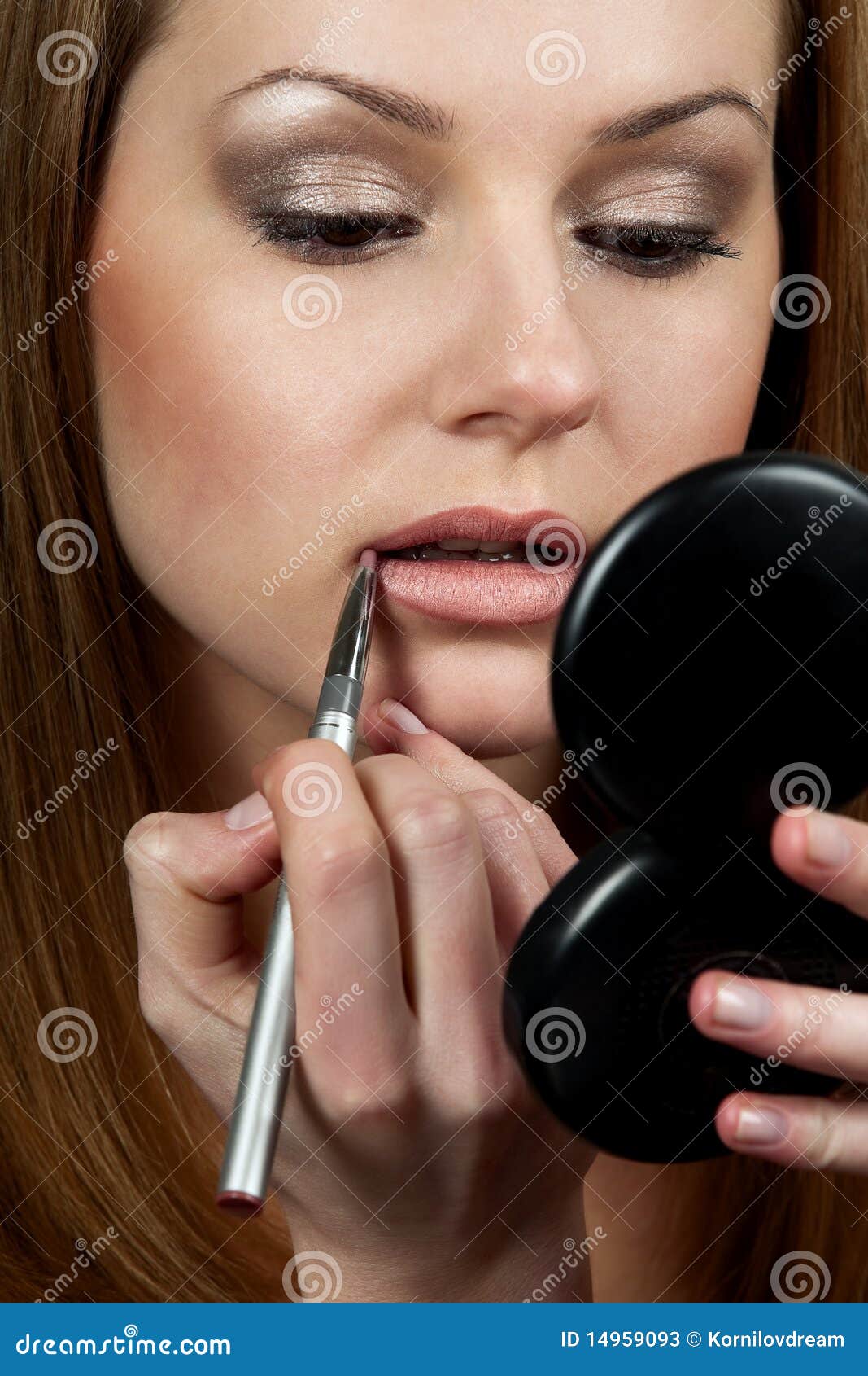 Woman applying make up stock image. Image of intense - 14959093