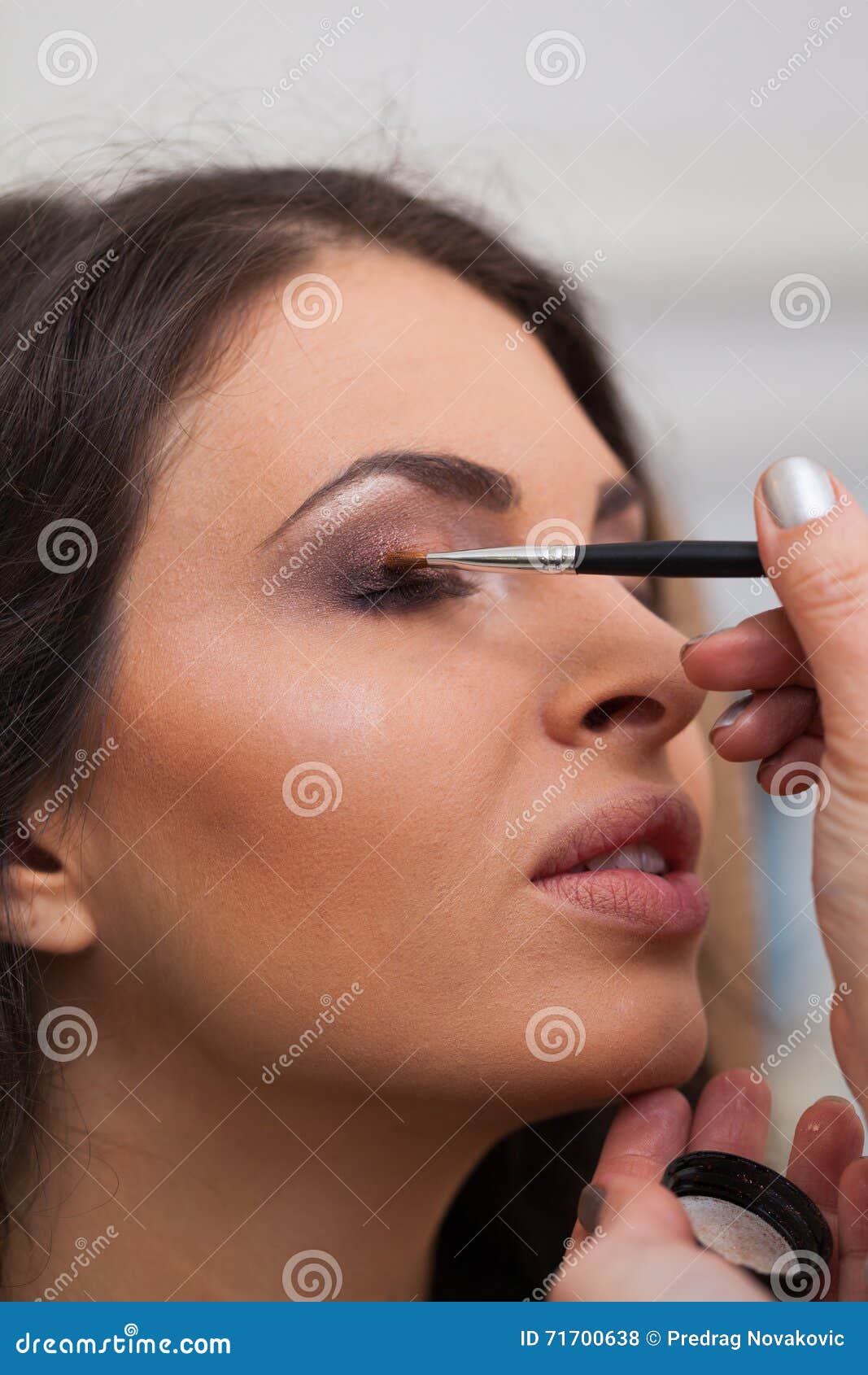 Woman applying make-up stock photo. Image of treatment - 71700638