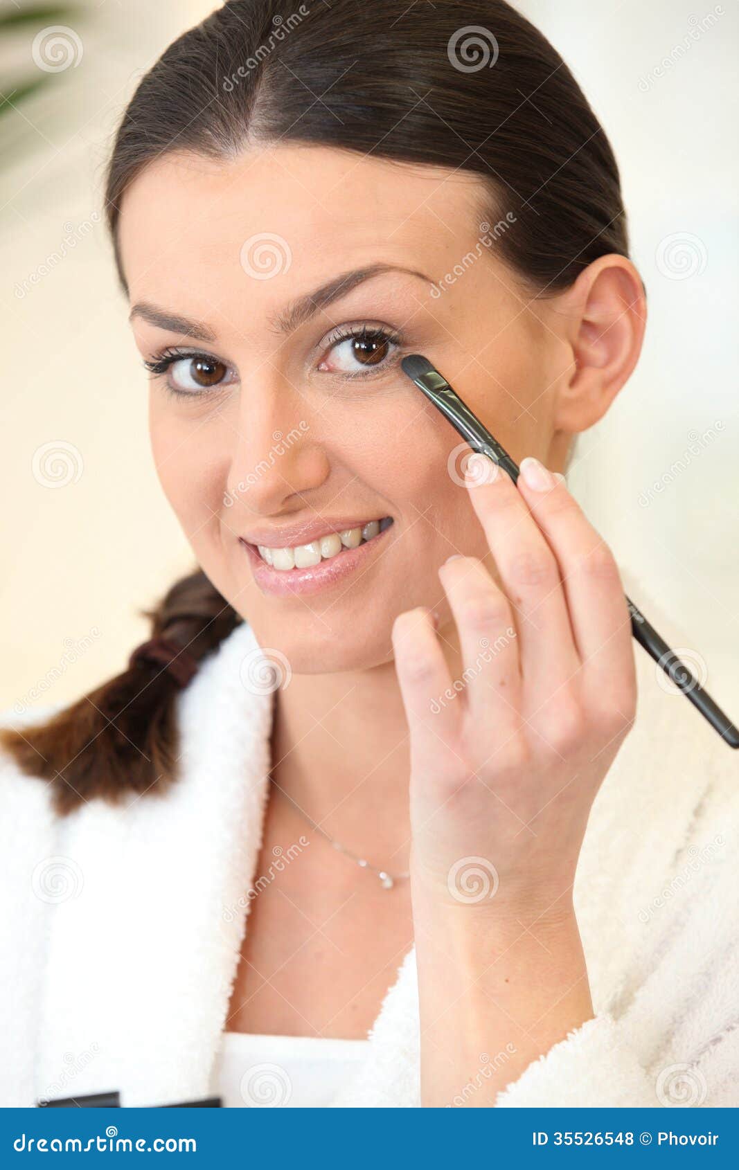 Woman applying make-up stock photo. Image of application - 35526548