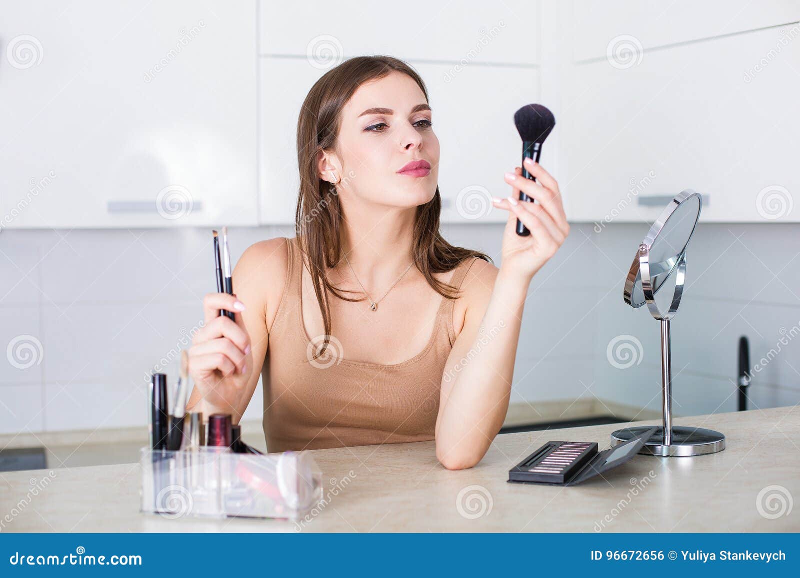 Woman applying makeup stock photo. Image of artist, beauty - 96672656