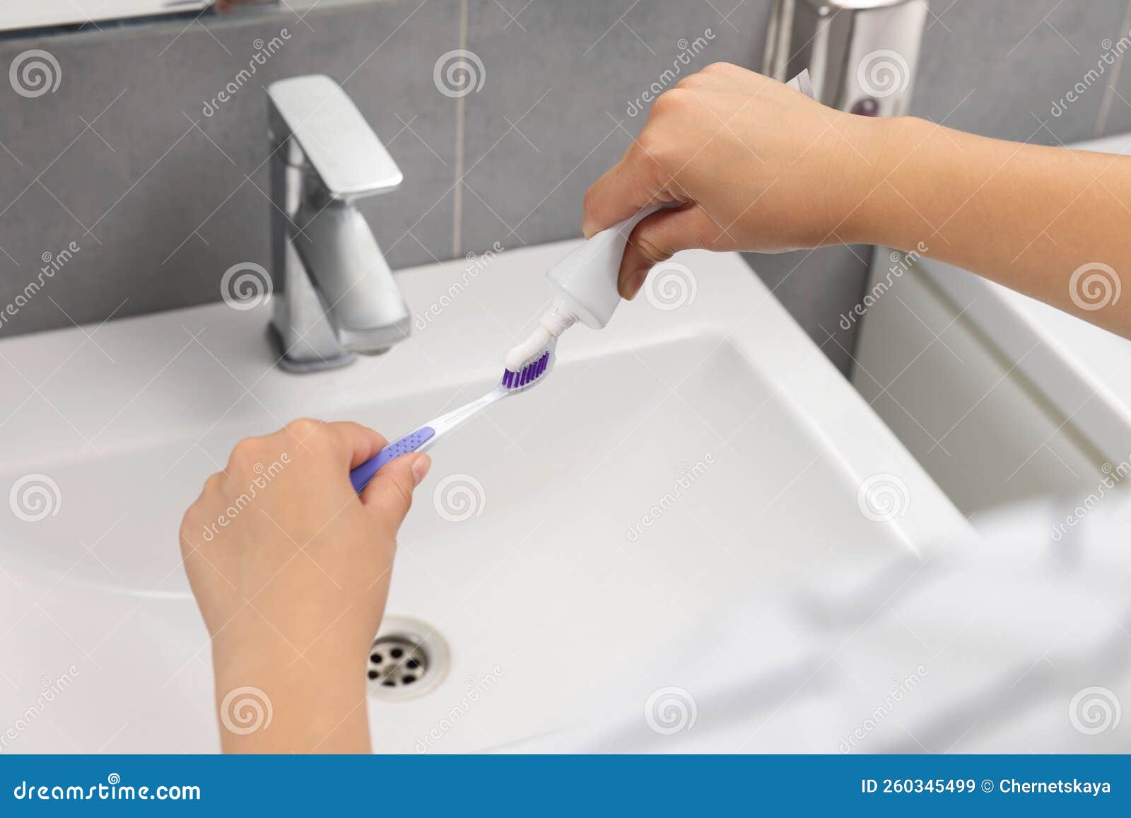 Woman Applying Toothpaste On Brush In Bathroom Closeup Stock Image