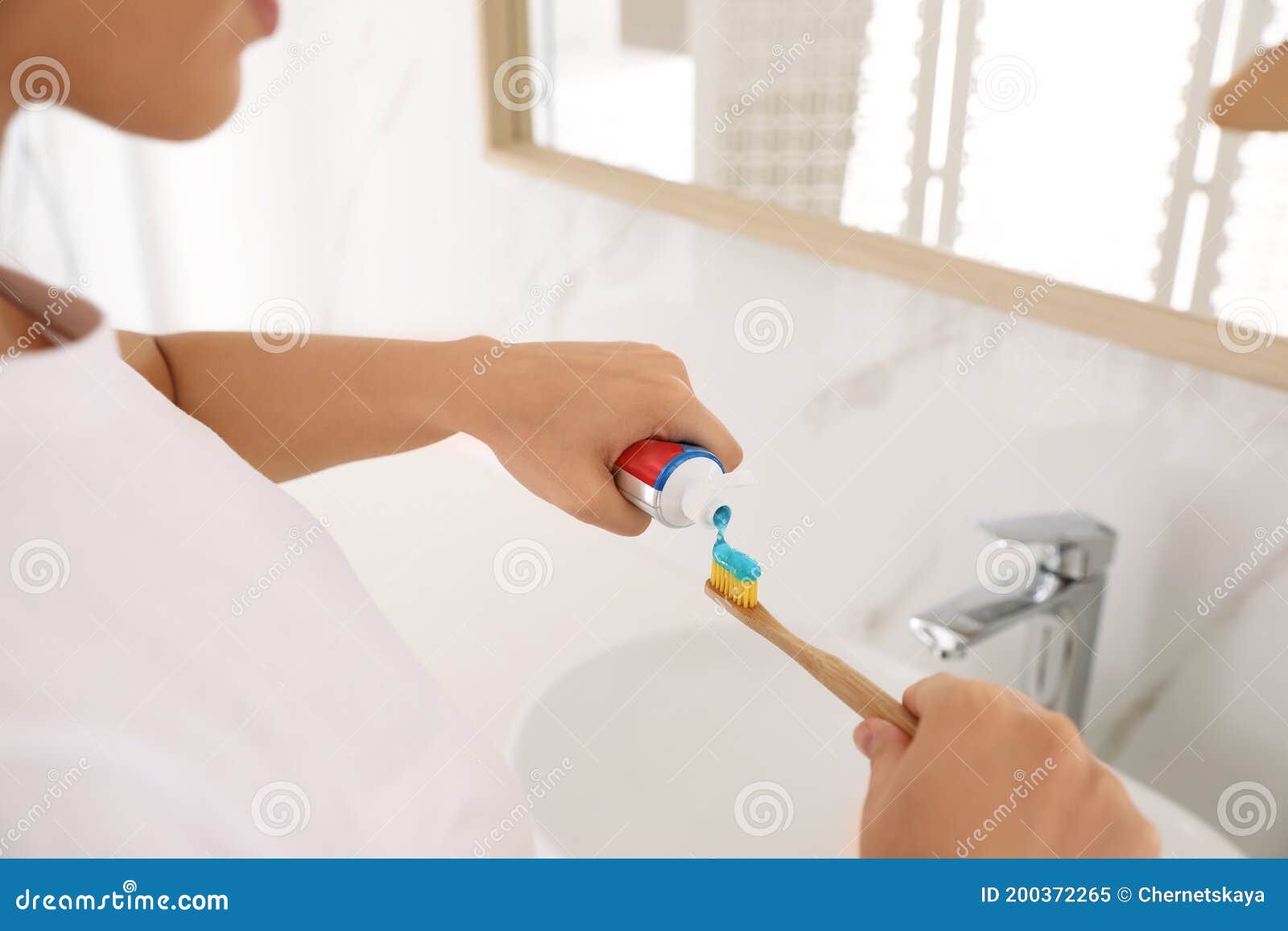 Woman Applying Toothpaste On Brush In Bathroom Closeup Stock Image