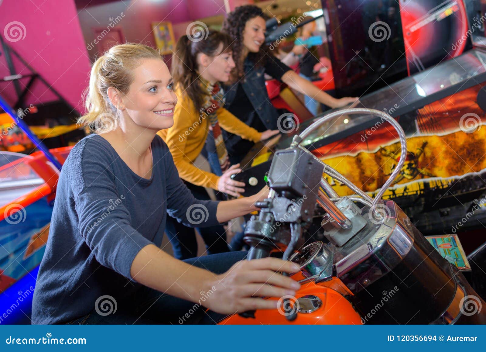 Woman on arcade motorcycle stock photo. Image of controls - 120356694