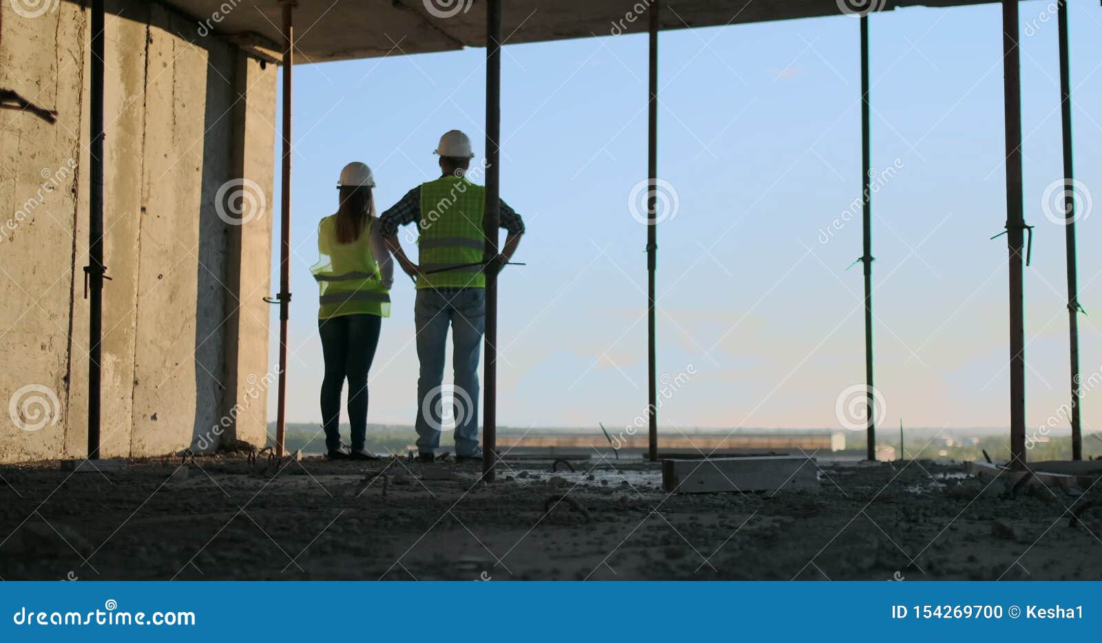 Woman Architect and Man Builder at Construction Site, Back View ...