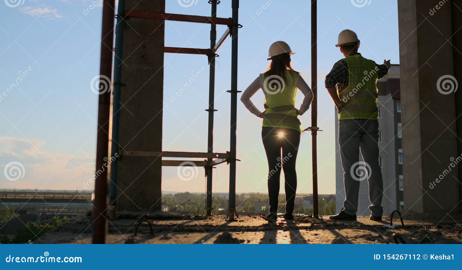 Woman Architect and Man Builder at Construction Site, Back View ...
