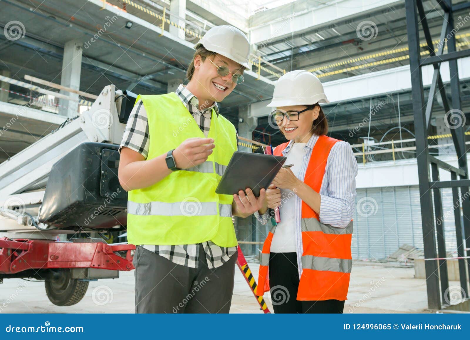 Woman Architect and Man Builder at a Construction Site. Building ...