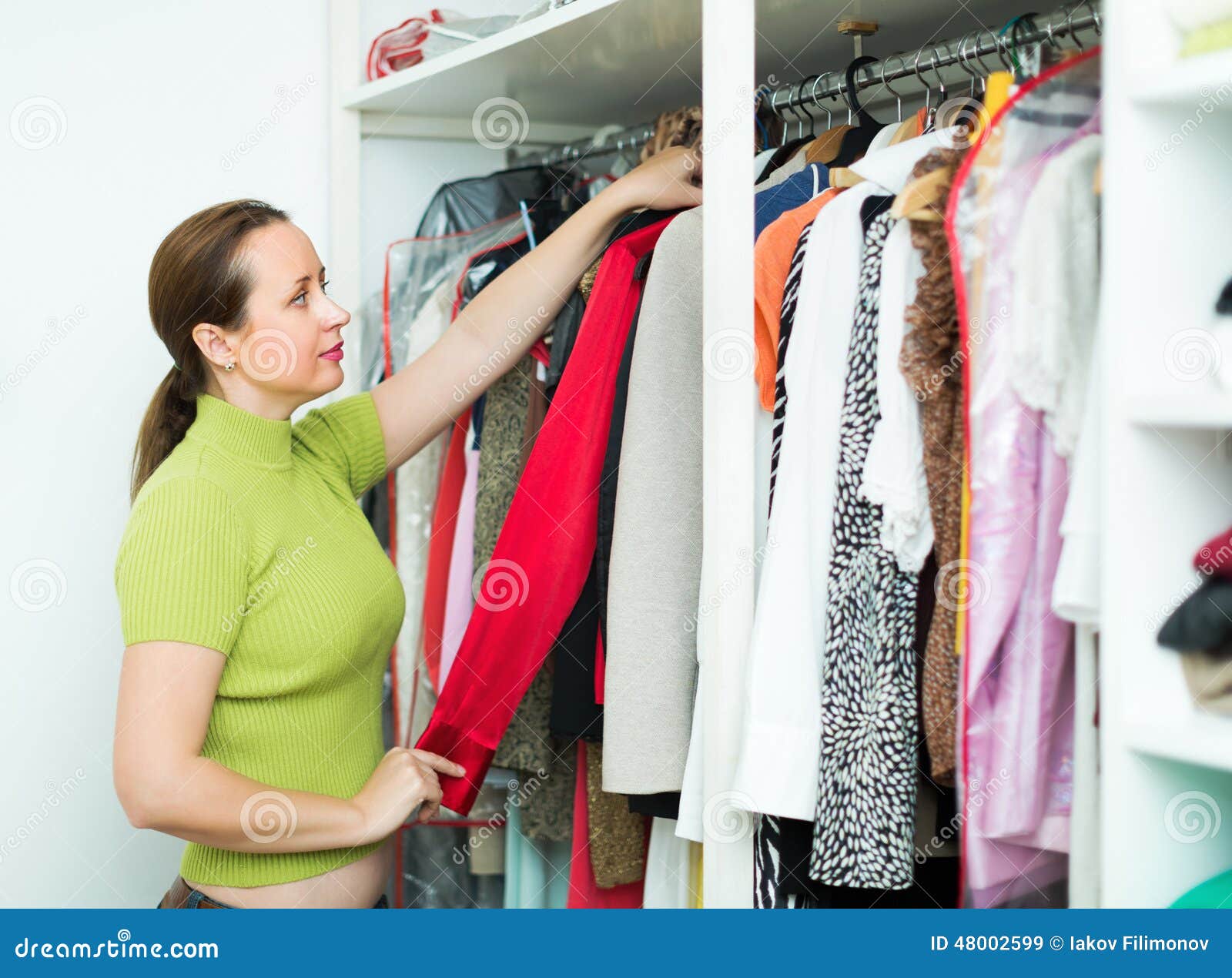 Woman Arranging Clothes at Wardrobe Stock Image - Image of closet ...