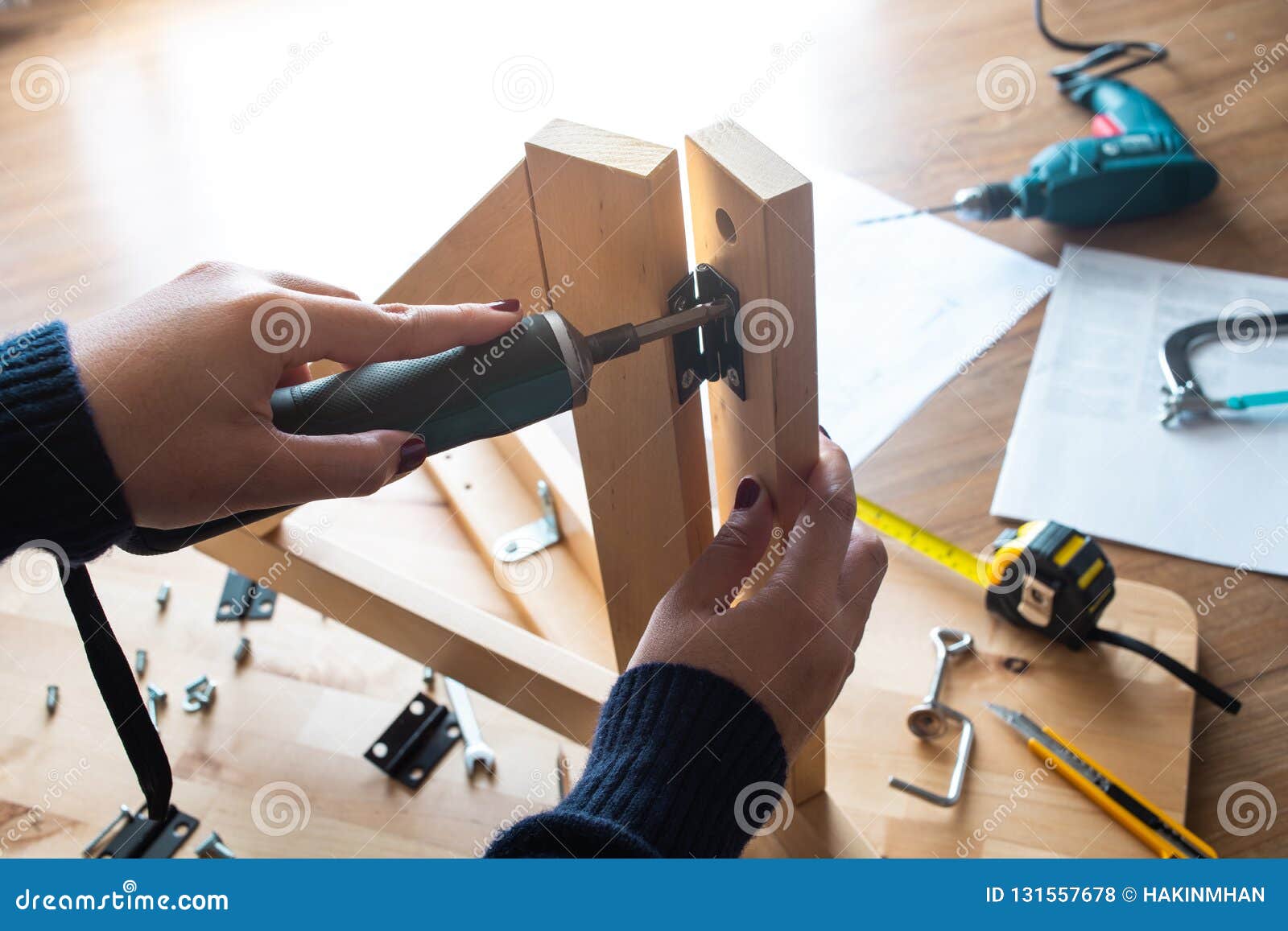 Woman Assembly Wooden Furniture Fixing Or Repairing House With
