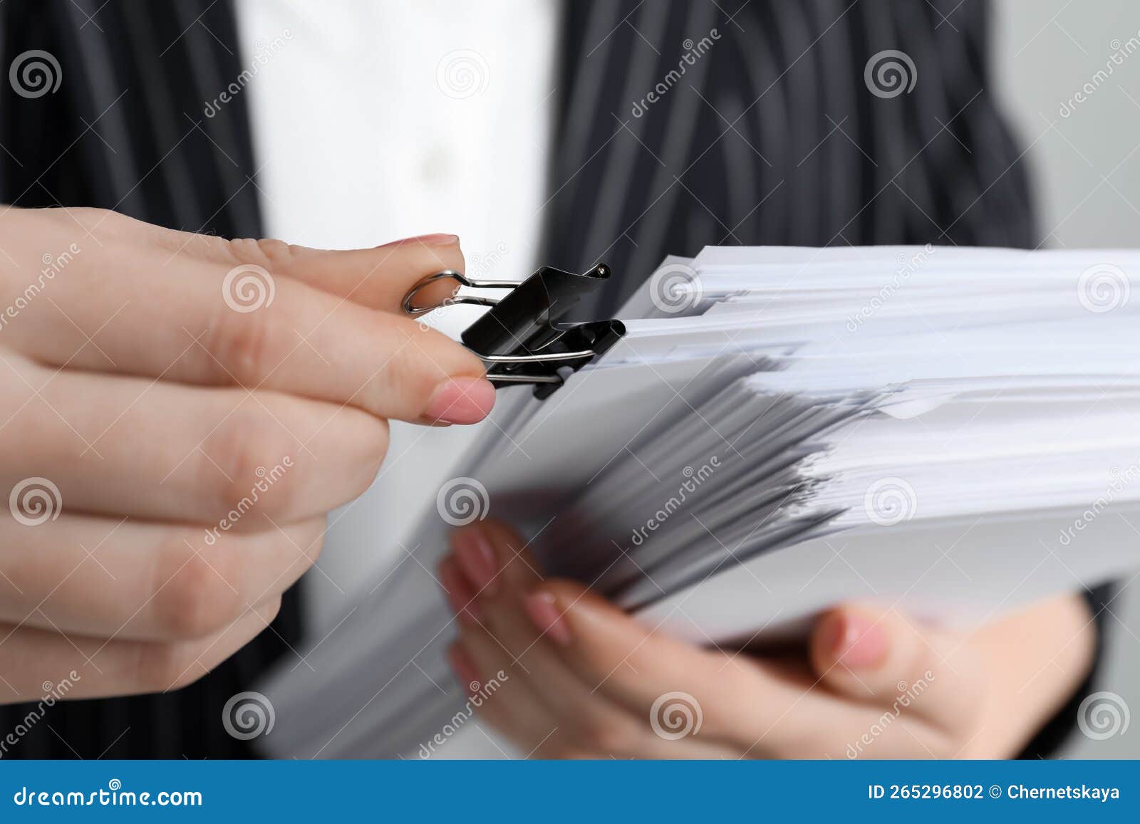 Woman Attaching Documents with Metal Binder Clip on Grey Background ...