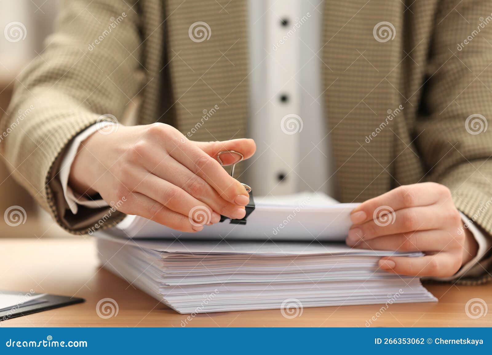 Woman Attaching Documents with Metal Binder Clip at Table in Office ...