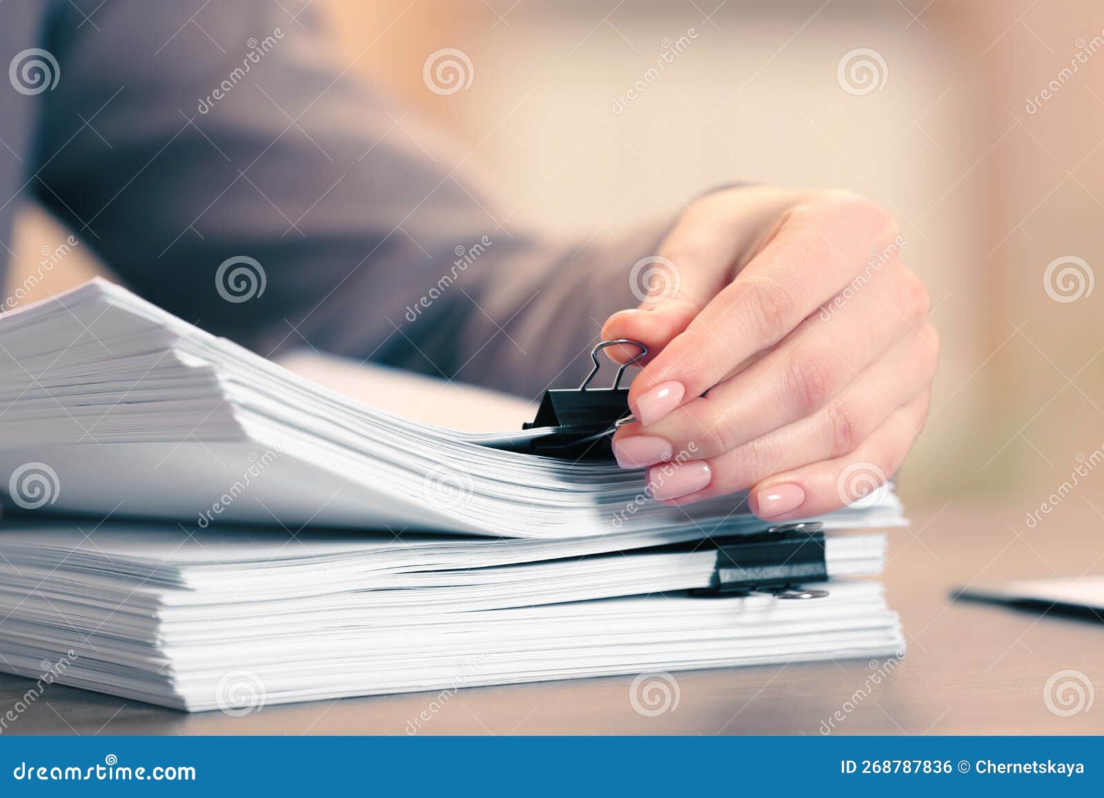 Woman Attaching Documents with Metal Binder Clip at Table in Office ...