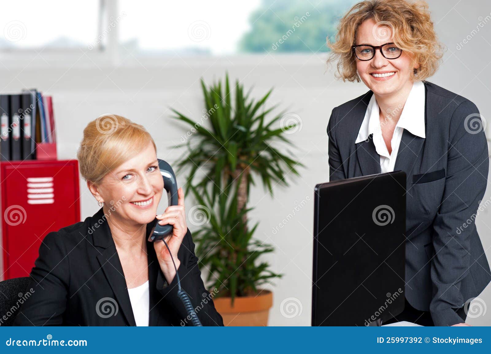 Woman Attending Call with Colleague beside Her Stock Photo - Image of ...