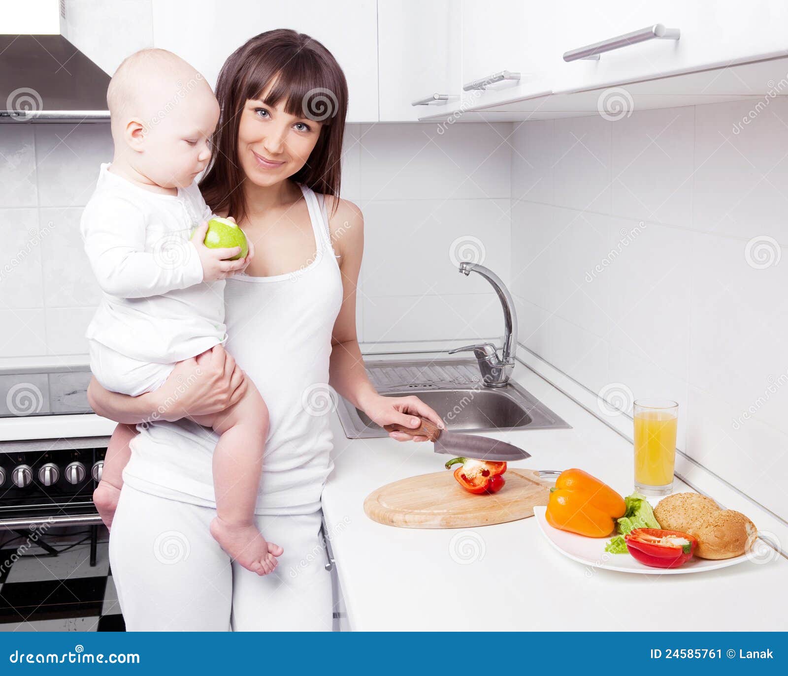 Woman with baby cooking stock image. Image of board, juice - 24585761