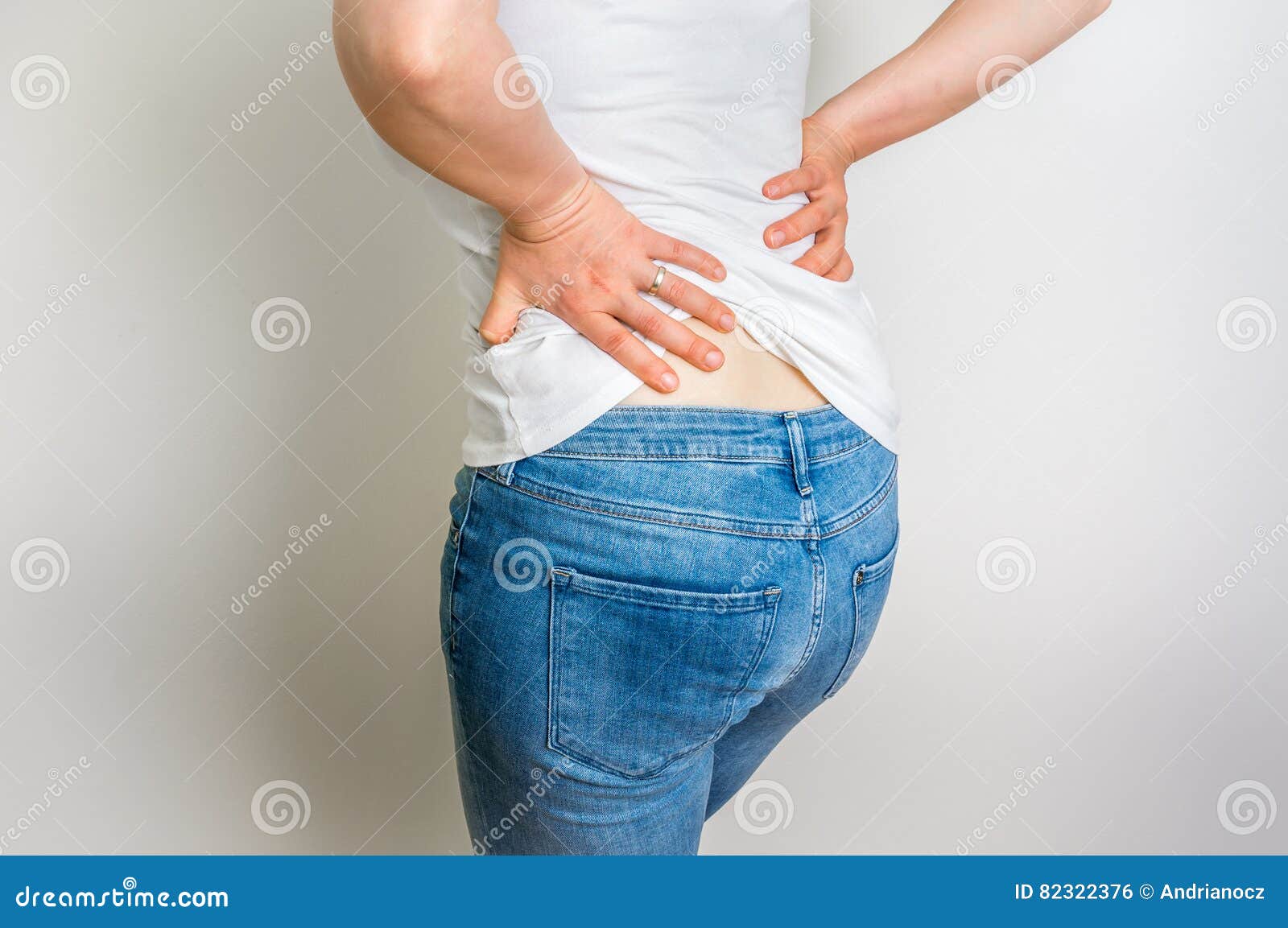 Woman with Back Pain Holding Her Aching Back Stock Photo - Image of ...