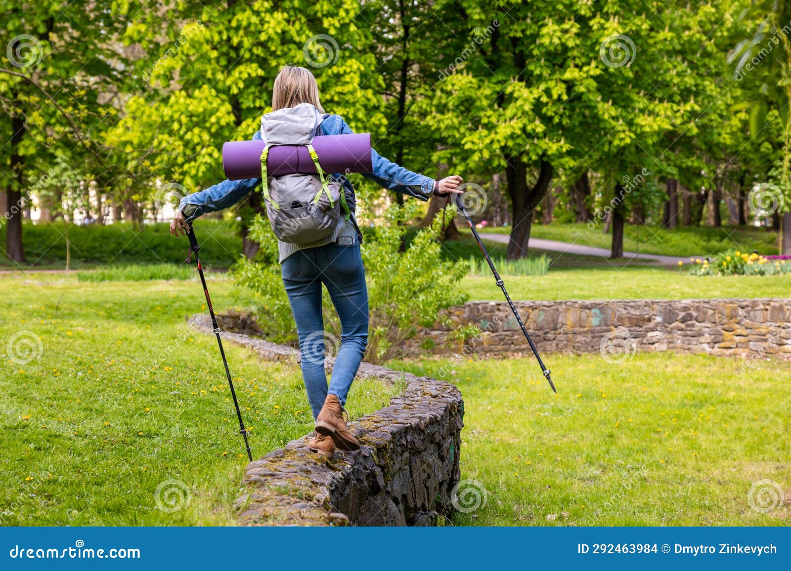 A Woman with Backpack and Scandinavian Sticks in the Forest Stock Photo ...