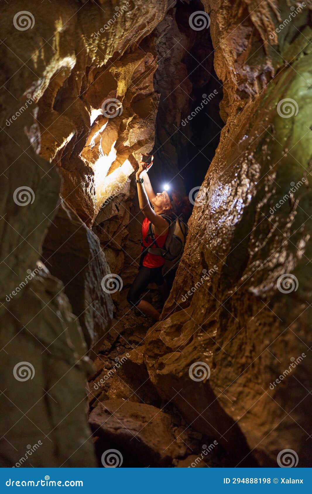 Woman with Backpack Taking Photos in a Cave Stock Photo - Image of ...