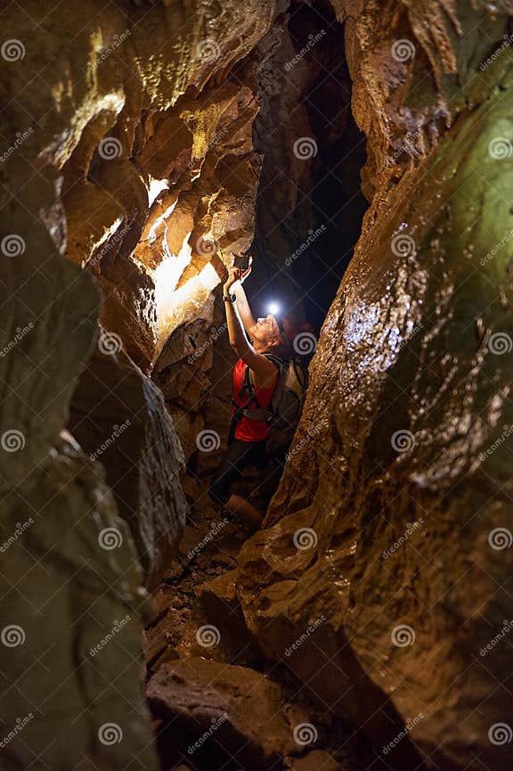 Woman with Backpack Taking Photos in a Cave Stock Photo - Image of ...