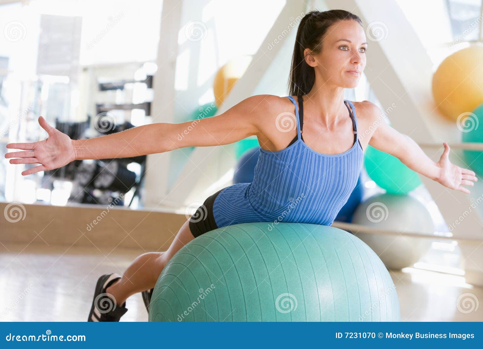 Woman Balancing on Swiss Ball Stock Photo - Image of angle, fitness ...
