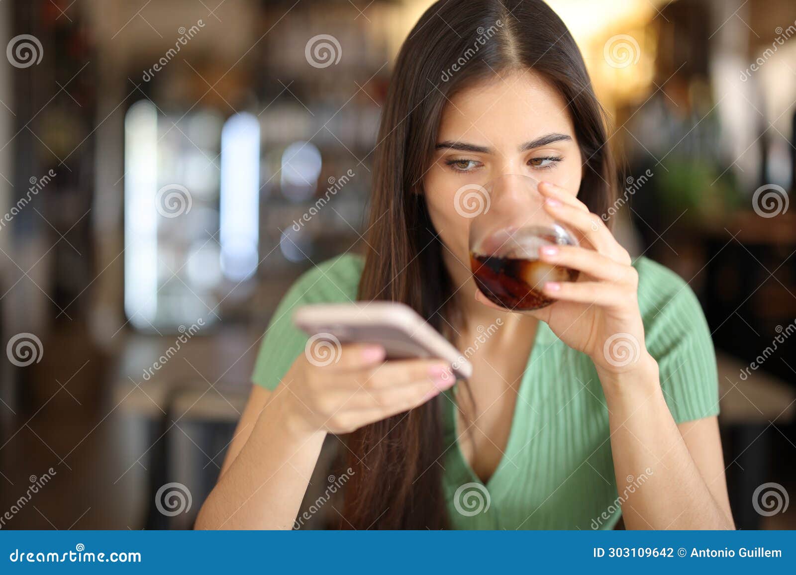 Woman in a Bar Checking Phone and Drinking Stock Photo - Image of phone ...