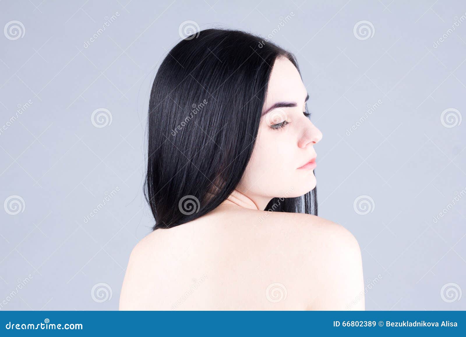 Woman with Bare Back on a Black Background Looking Down Stock Image ...